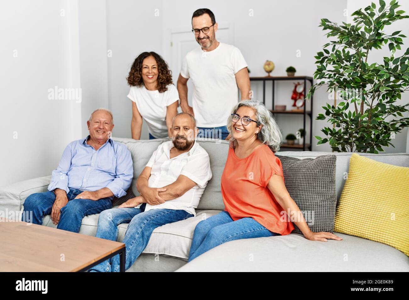 Group of middle age friends smiling happy sitting on the sofa at home ...