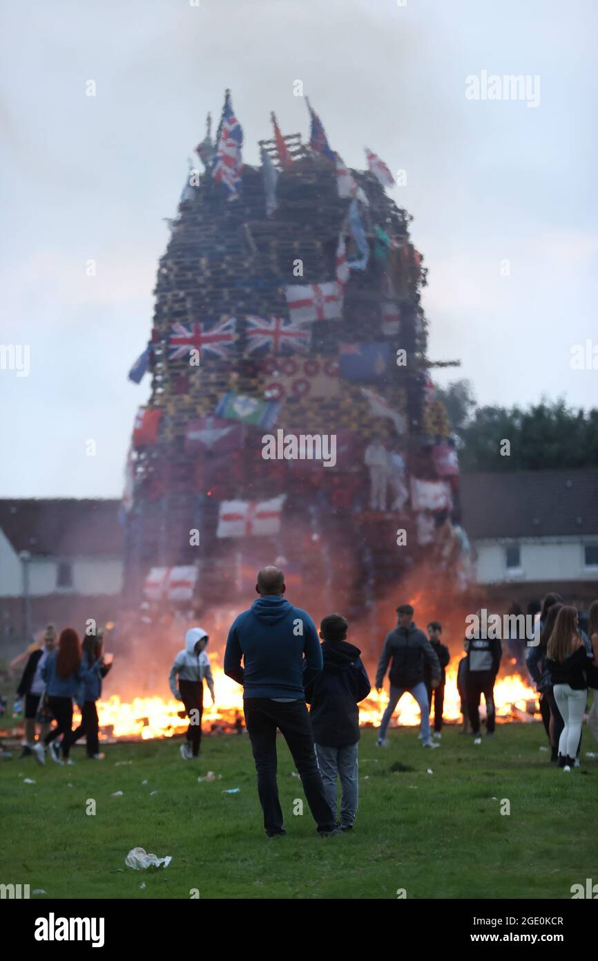 Flags and banners hang from a large bonfire which has been lit to mark ...