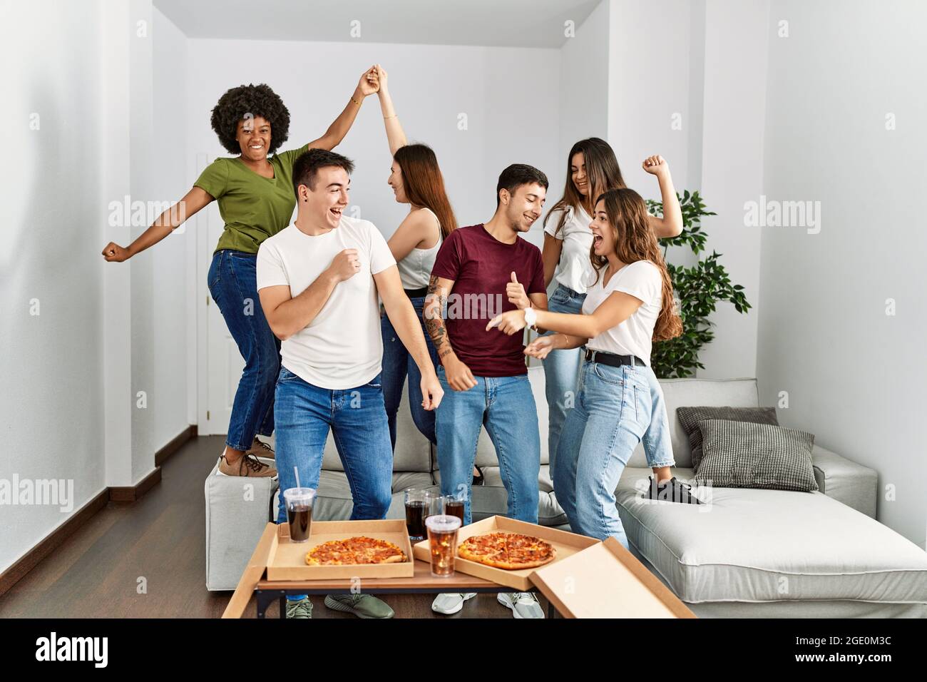 Group of young friends having party eating italian pizza and and ...