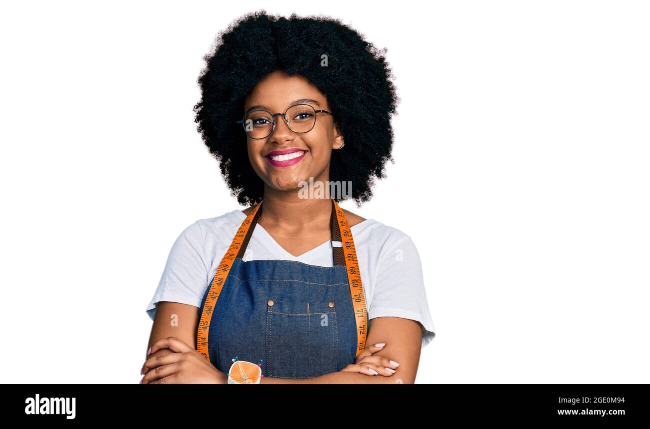 Young african american woman dressmaker designer wearing atelier apron smiling with a happy and ...