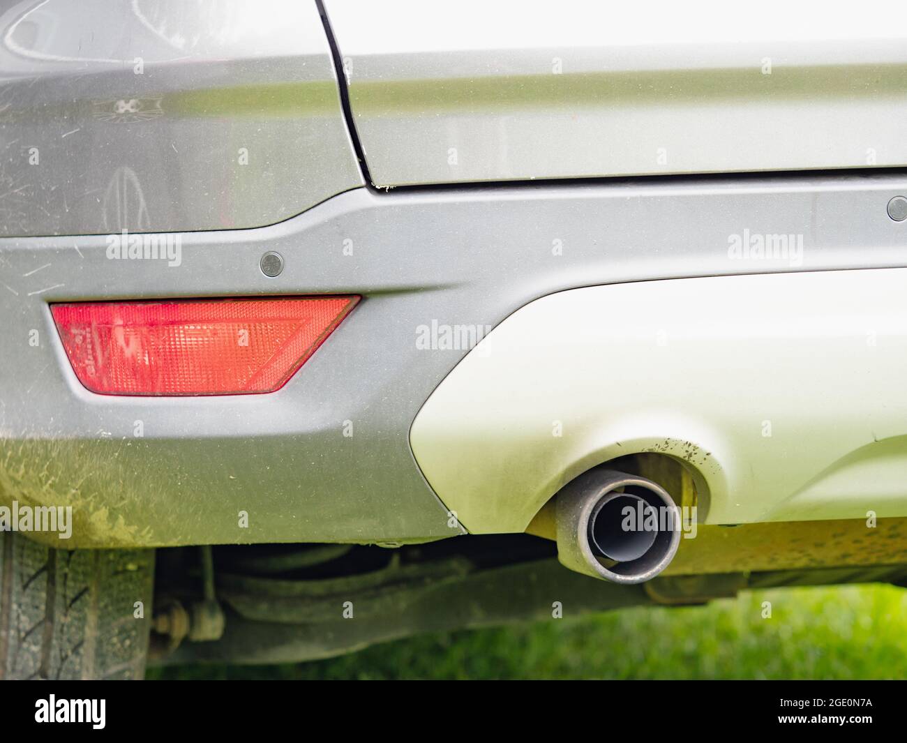 Car exhaust pipe, rear low angle view. Car parking on short grass Stock ...