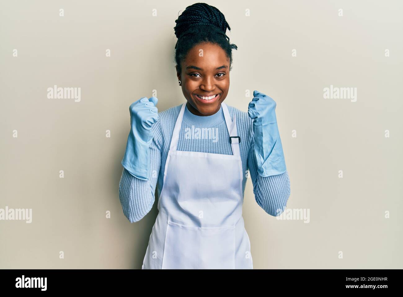 African american woman with braided hair wearing cleaner apron and ...
