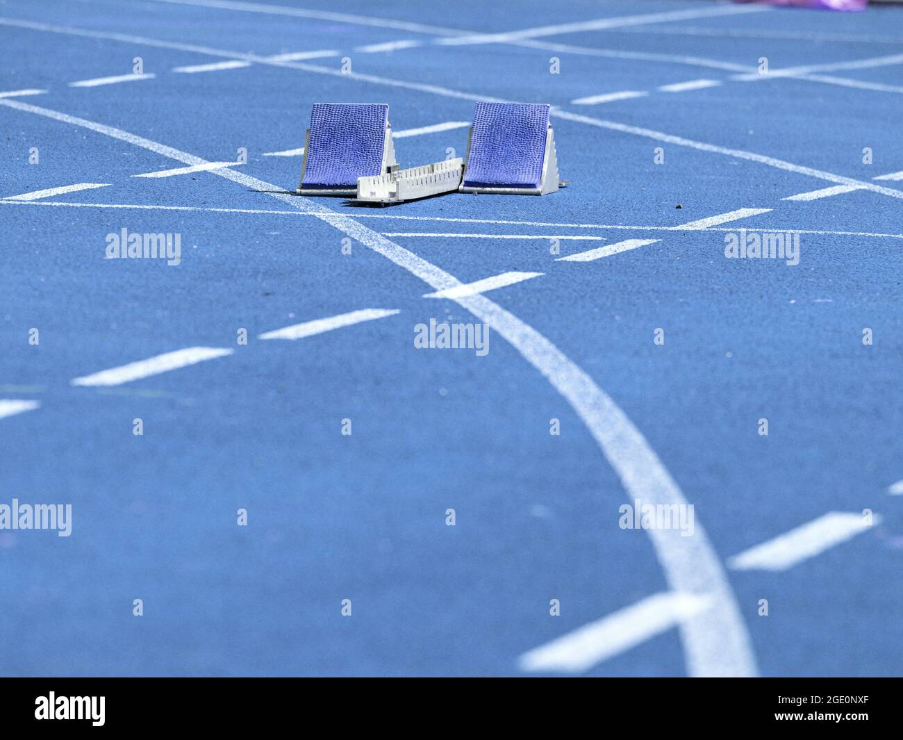 Starting blocks ready on blue running tracks lanes at track and field ...