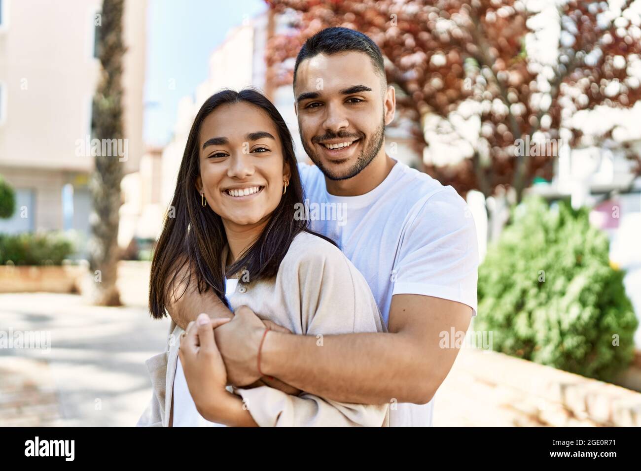 Young latin couple smiling happy and hugging at the city Stock Photo ...
