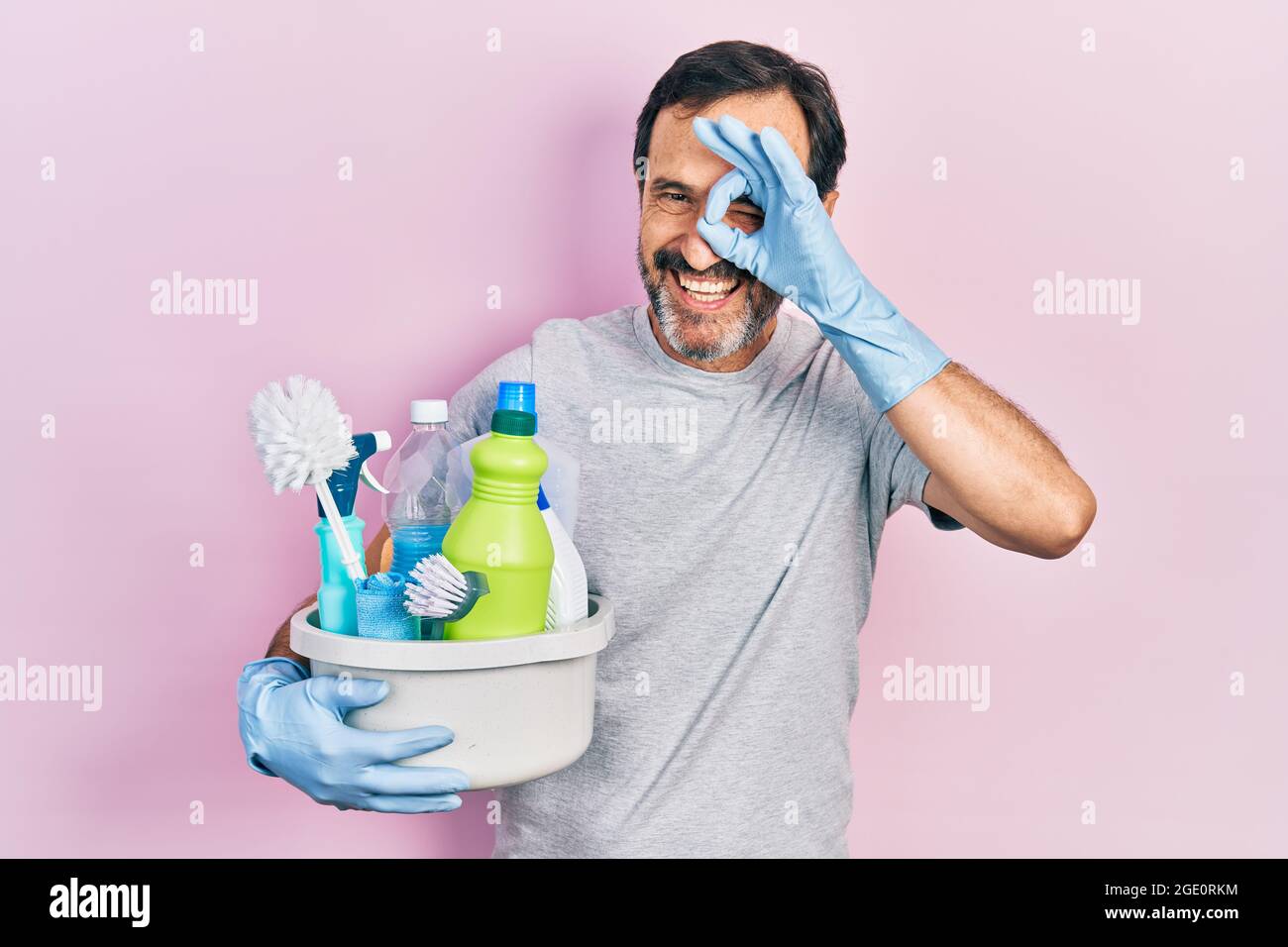 Middle age hispanic man holding cleaning products smiling happy doing ...