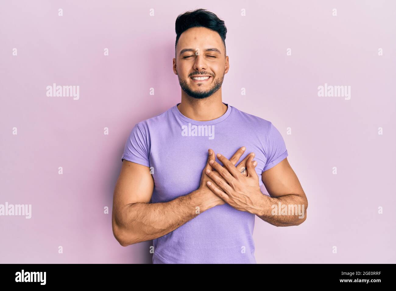 Young arab man wearing casual clothes smiling with hands on chest with ...