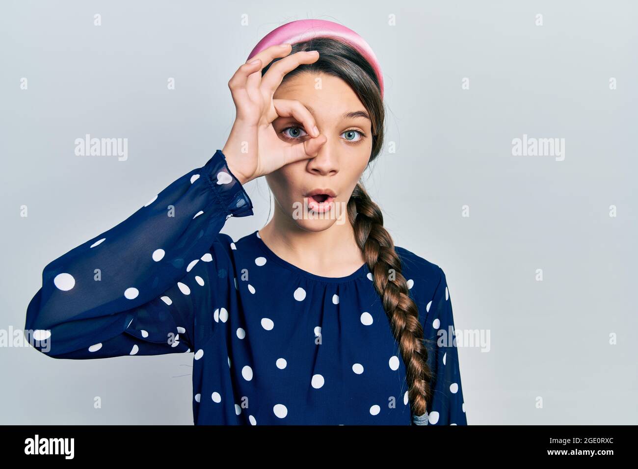 Young brunette girl wearing elegant look doing ok gesture shocked with ...