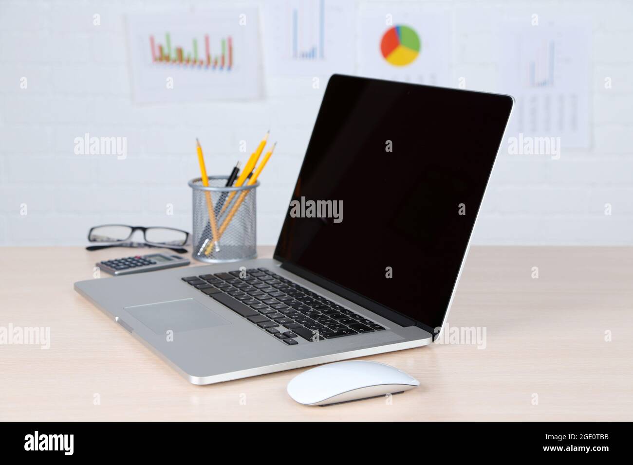 Modern laptop on table, on white wall background Stock Photo - Alamy