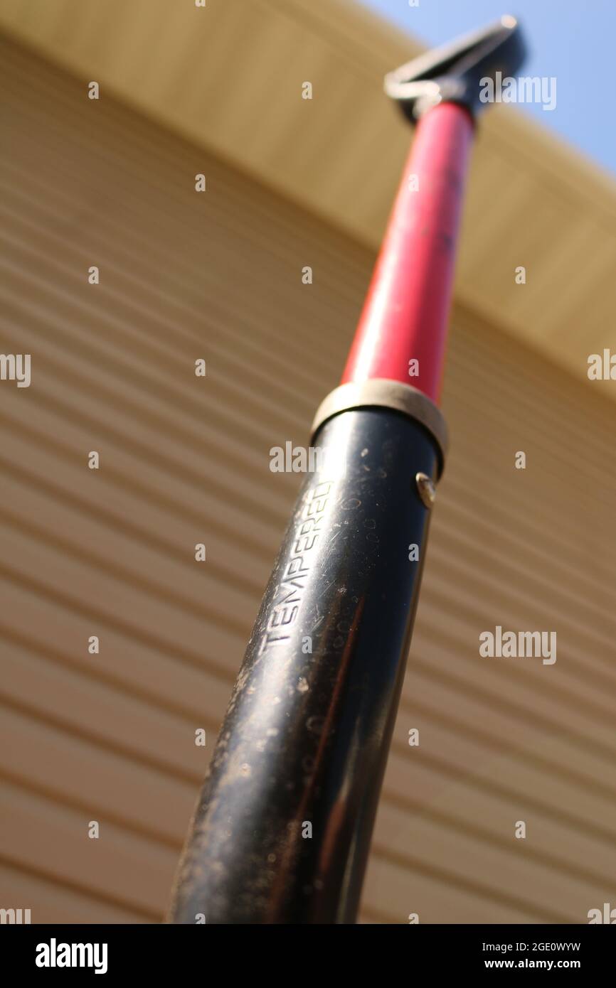 Red handle of a shovel Stock Photo - Alamy