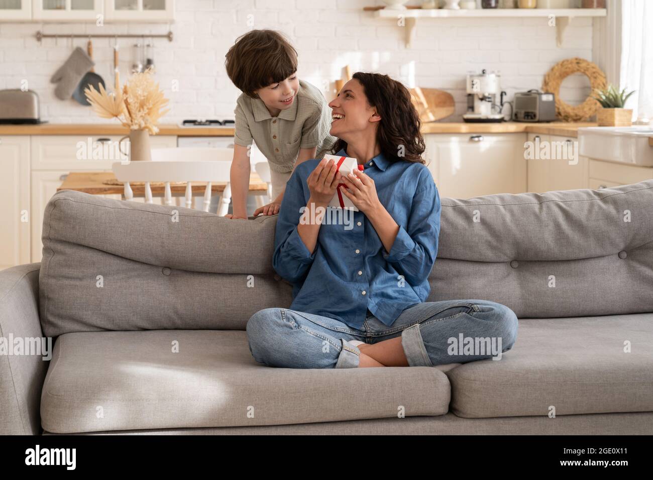 Little son make birthday surprise to mum greeting female parent with ...