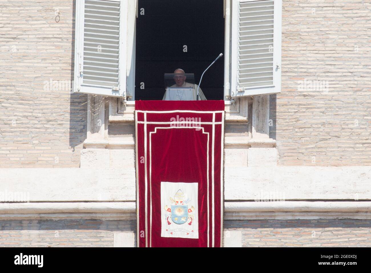 Pope Francis waves from the window of the apostolic palace overlooking ...