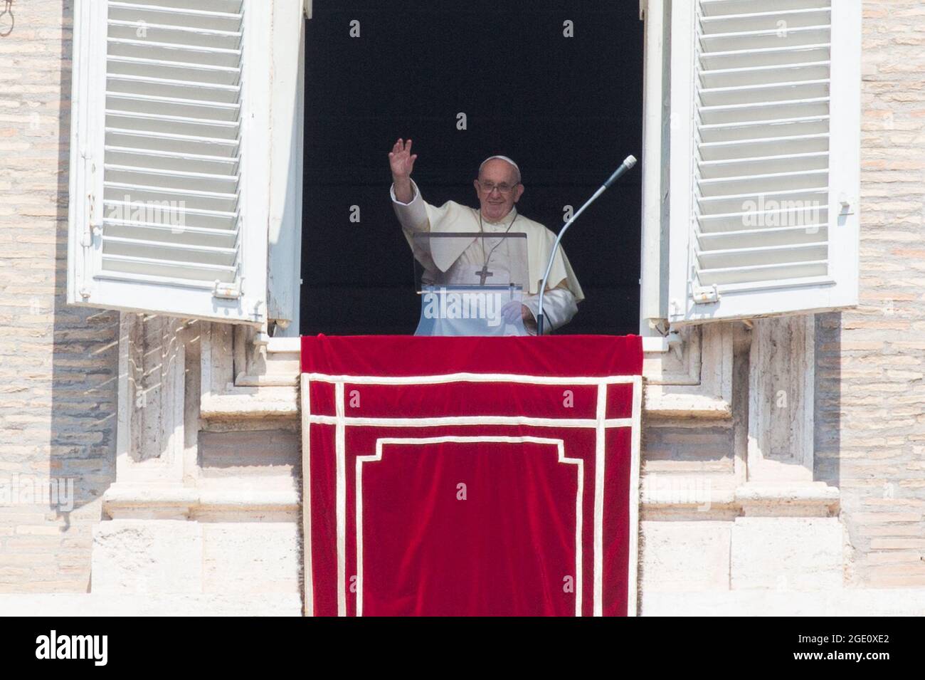 Pope Francis waves from the window of the apostolic palace overlooking ...
