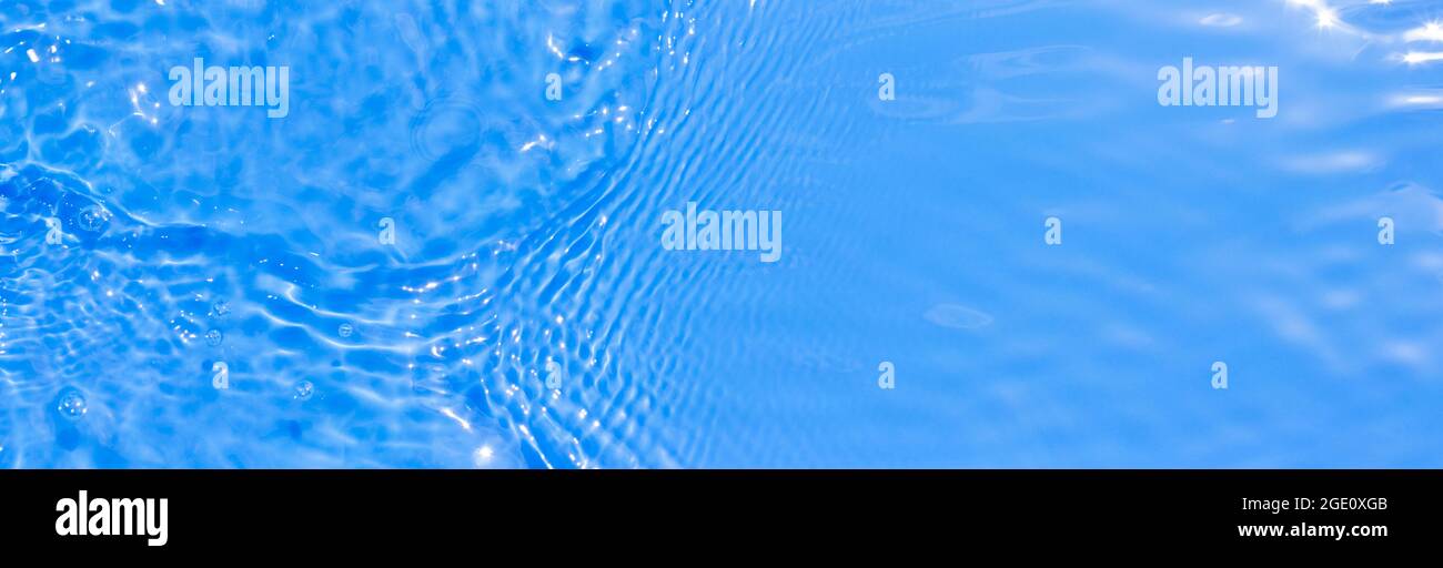 Surface of blue transparent swimming pool water texture with light ...