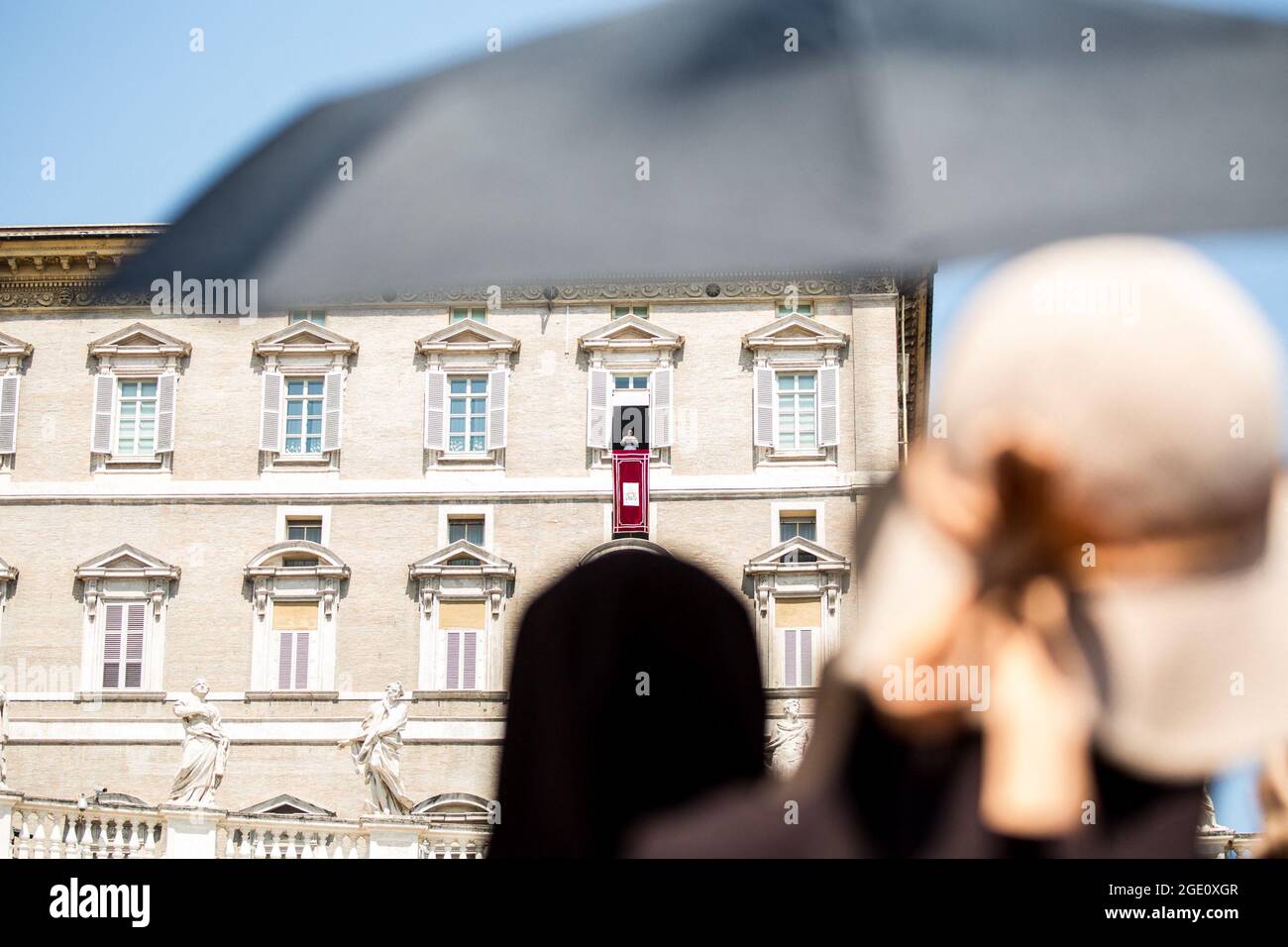 Pope Francis waves from the window of the apostolic palace overlooking ...
