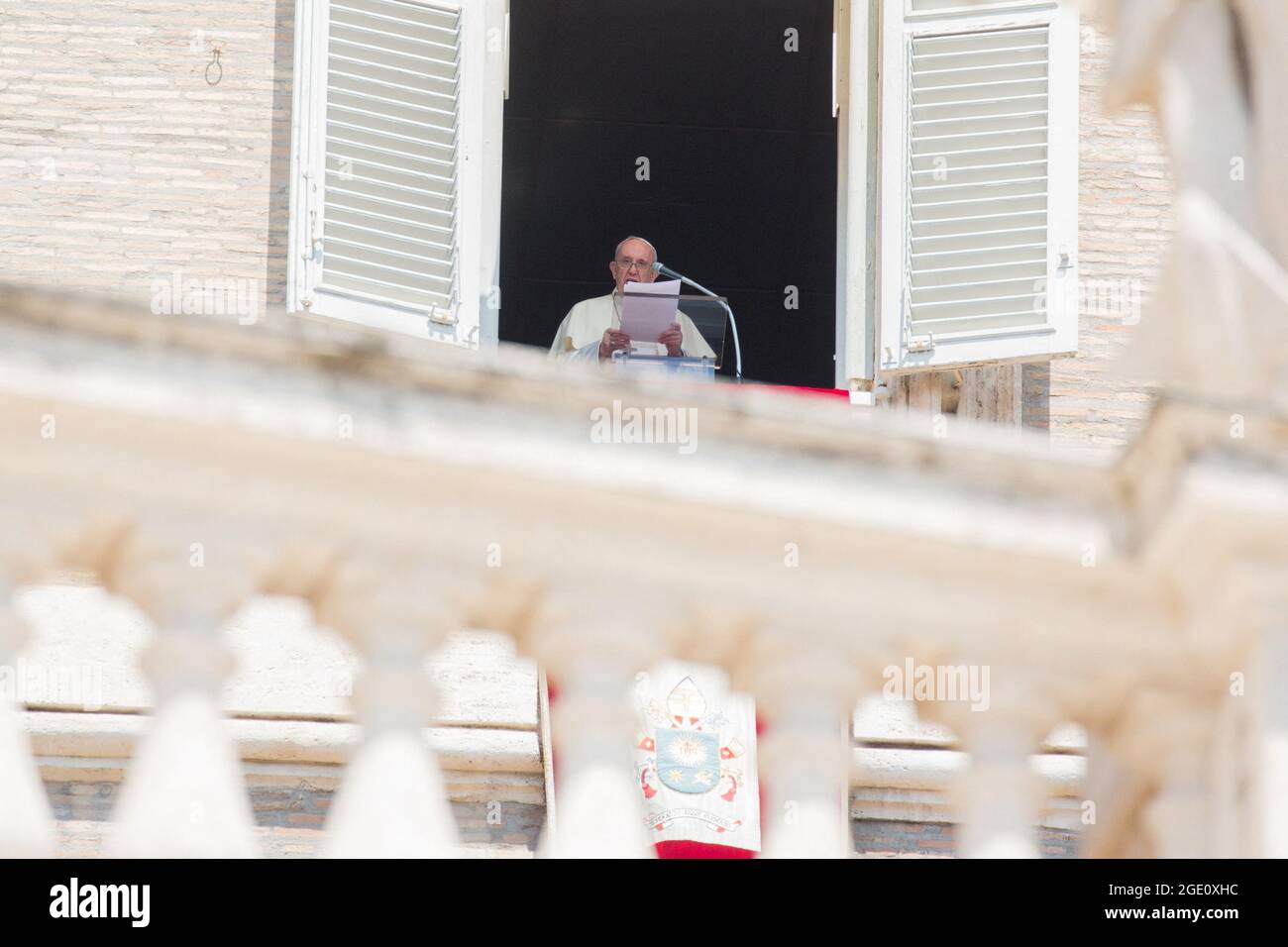 Pope Francis waves from the window of the apostolic palace overlooking ...