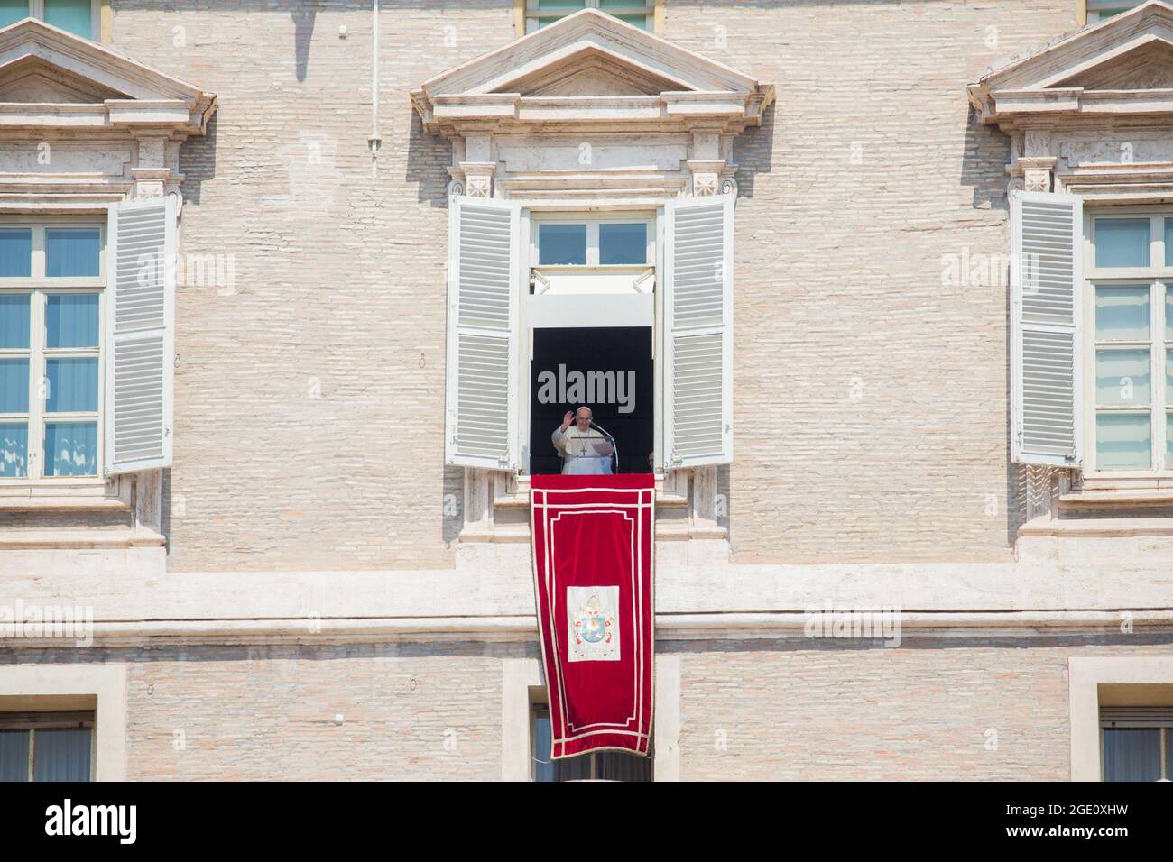 Pope Francis waves from the window of the apostolic palace overlooking ...