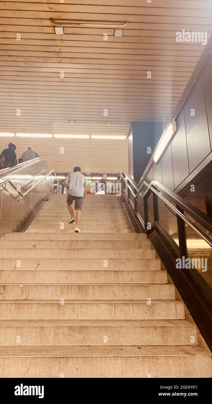 A back view of a male going upstairs Stock Photo - Alamy