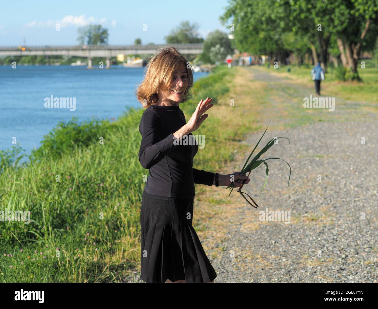A Caucasian women from Italy walking in the riverside Stock Photo - Alamy