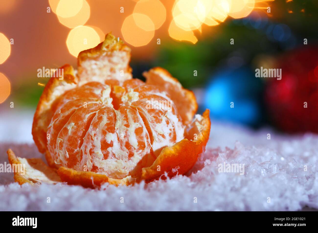 Fresh ripe mandarin on snow, on lights background Stock Photo - Alamy