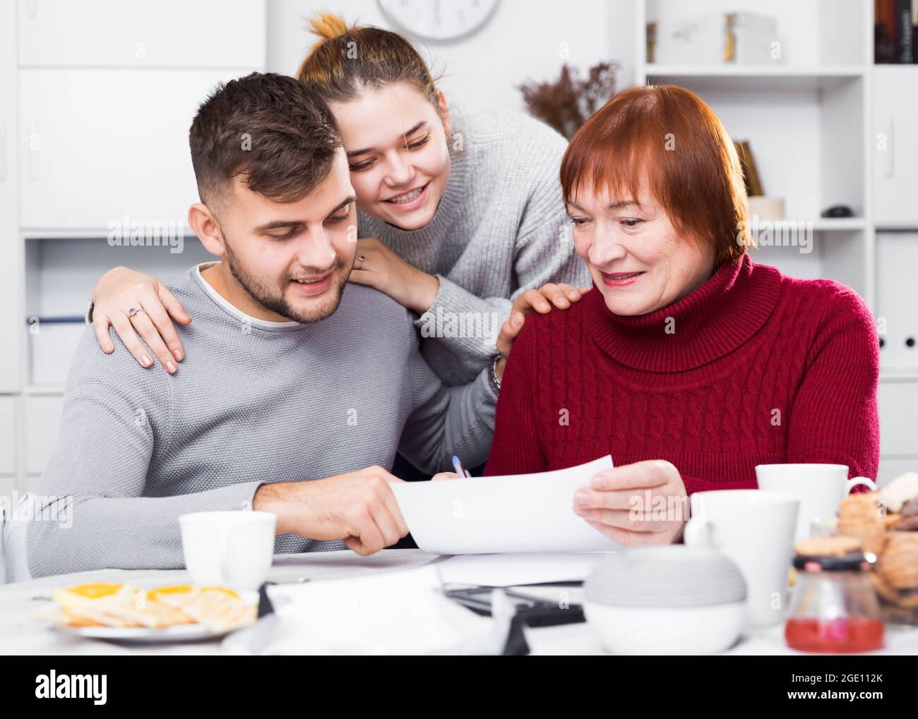 Happy family reading mail together Stock Photo - Alamy