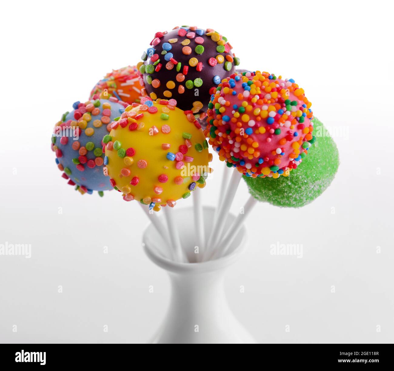 Sweet cake pops in vase isolated on white Stock Photo - Alamy