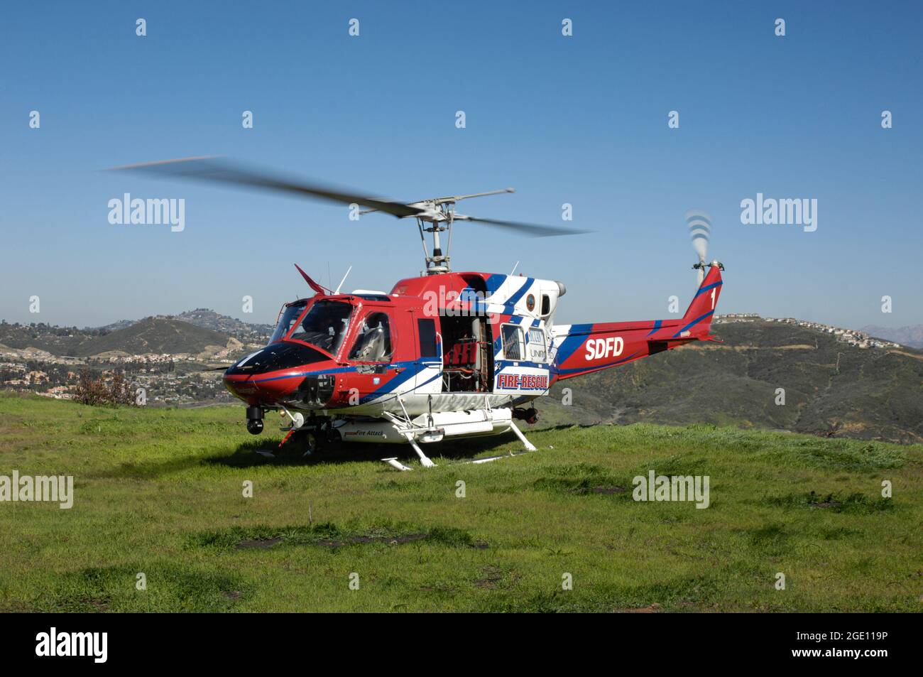 San Diego Fire-Rescue Copter 1 on hilltop prior to beginning airlift of ...
