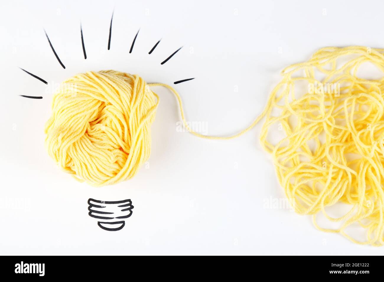 Symbol of idea as light bulb on sheet of paper from skein of thread ...