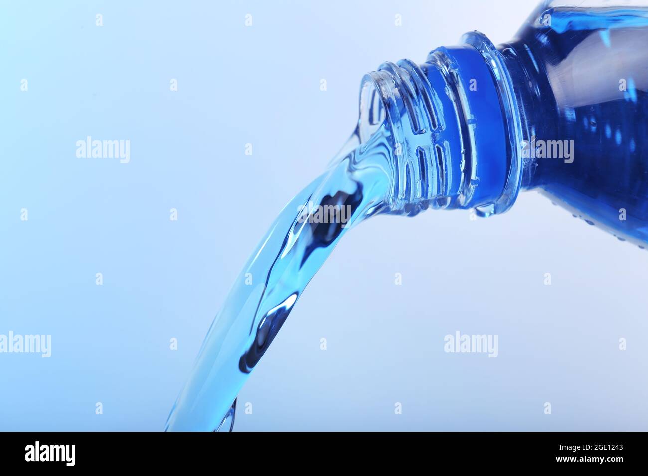 Pouring water on light background Stock Photo - Alamy