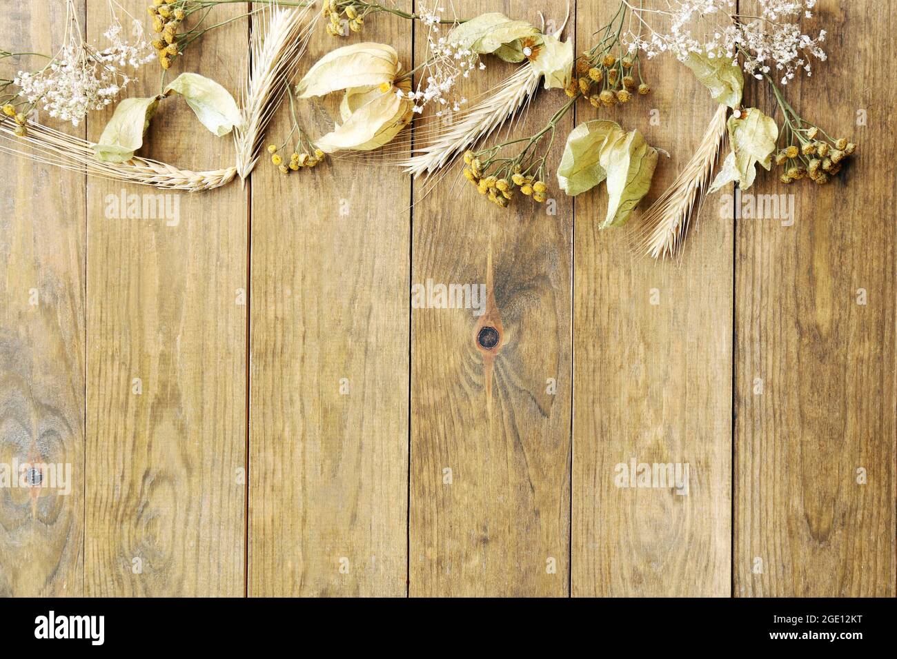 Dried wheat on rustic wooden planks background Stock Photo - Alamy