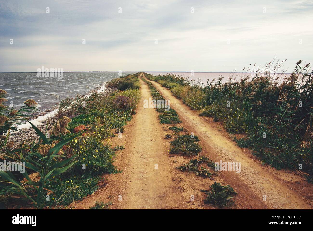 Road to nowhere - empty sand spit road through salt lake Stock Photo ...