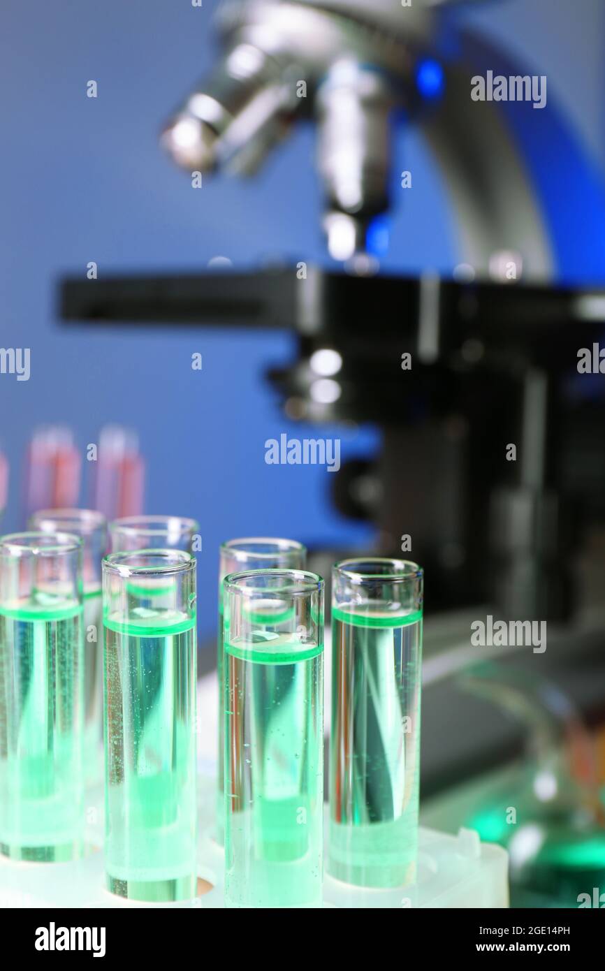Test tubes on microscope background Stock Photo - Alamy