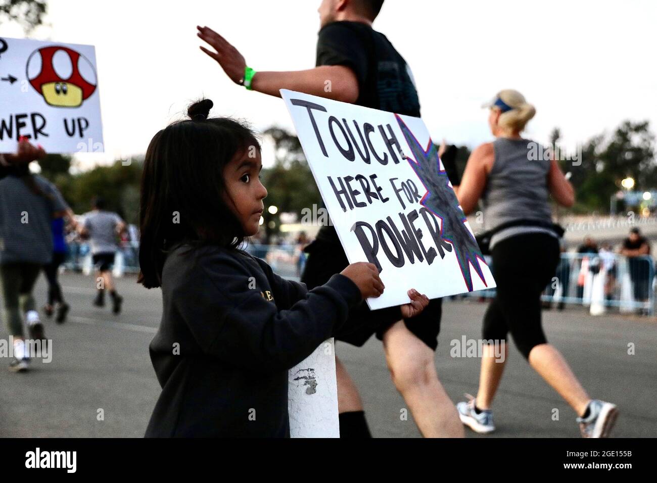 Los Angeles, USA. 15th Aug, 2021. A child holds a "Touch Here For Power ...