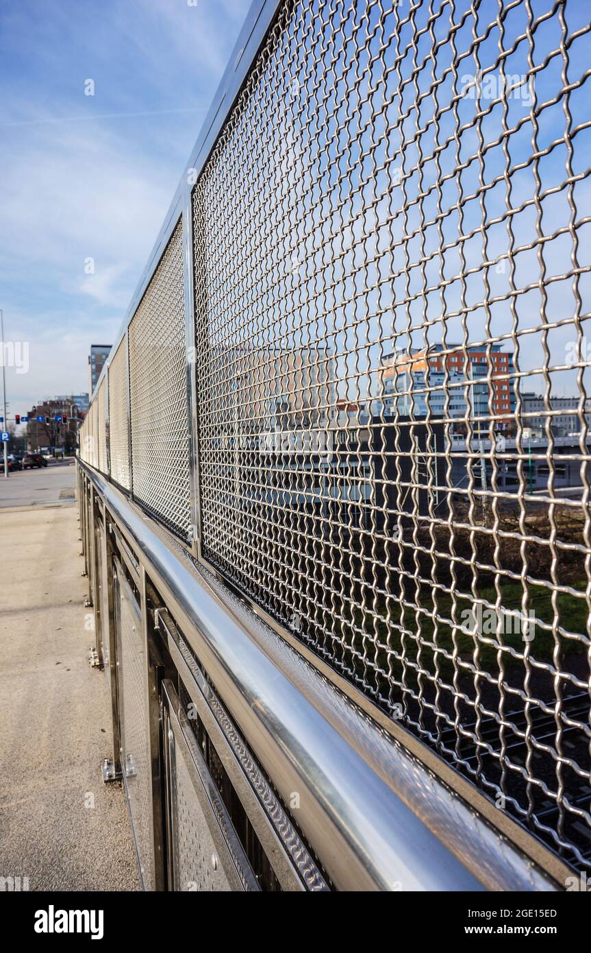 A metal grid fence over the window of a modern building Stock Photo - Alamy