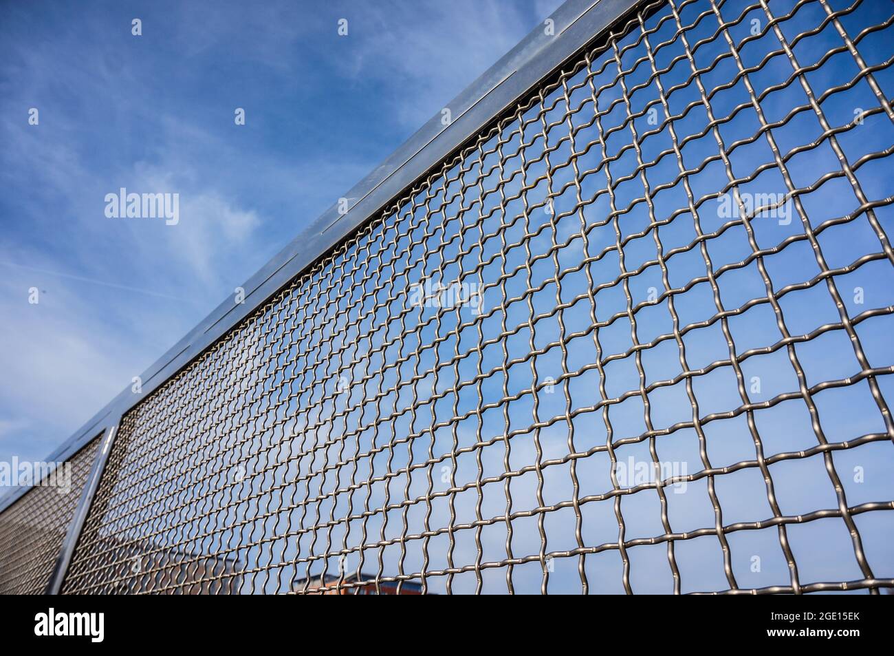 A metal grid fence over the window of a modern building Stock Photo - Alamy
