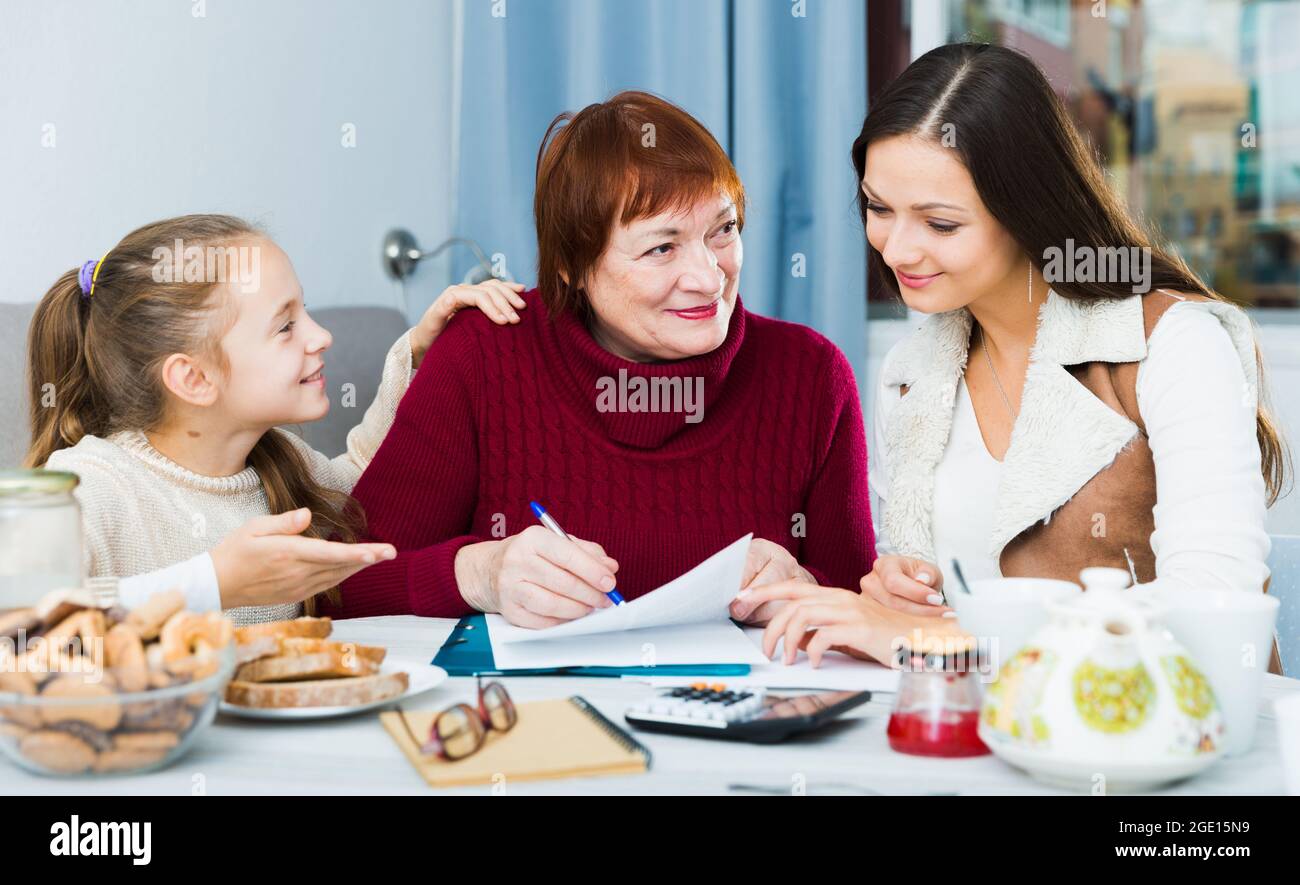 Happy family working with papers Stock Photo - Alamy