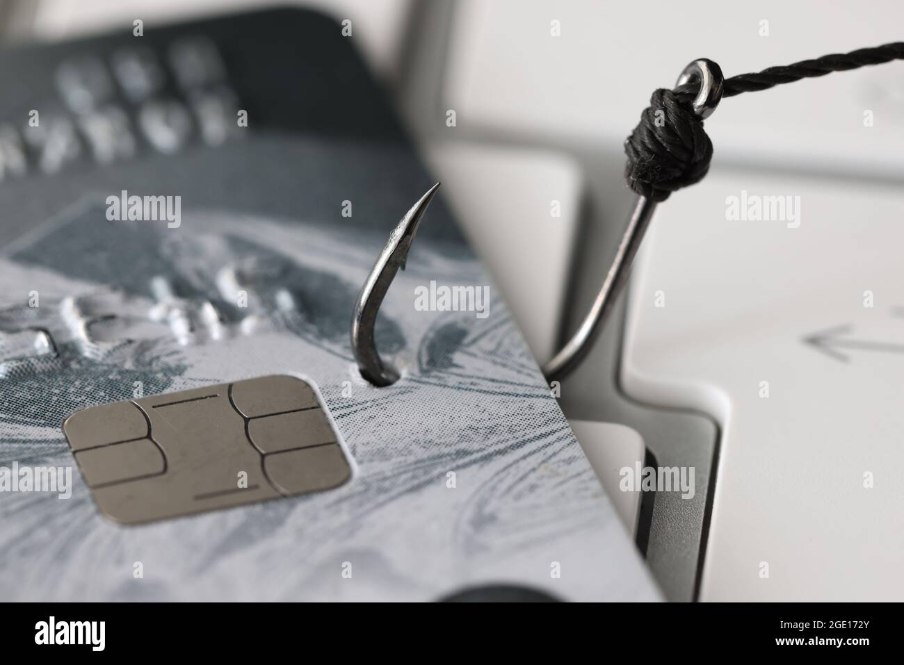 Bank card tied to hook lying on computer keyboard closeup Stock Photo ...