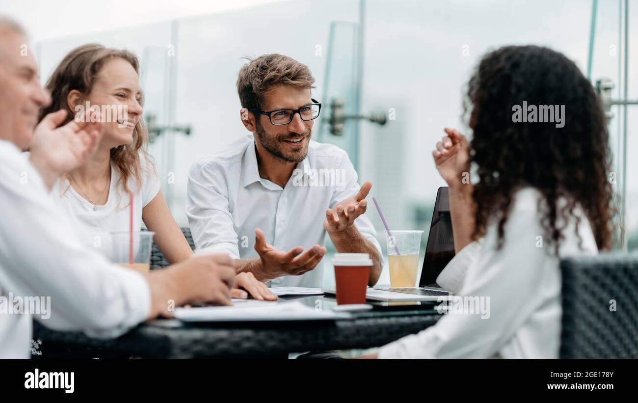 business people are talking sitting at a table in the lobby of the ...