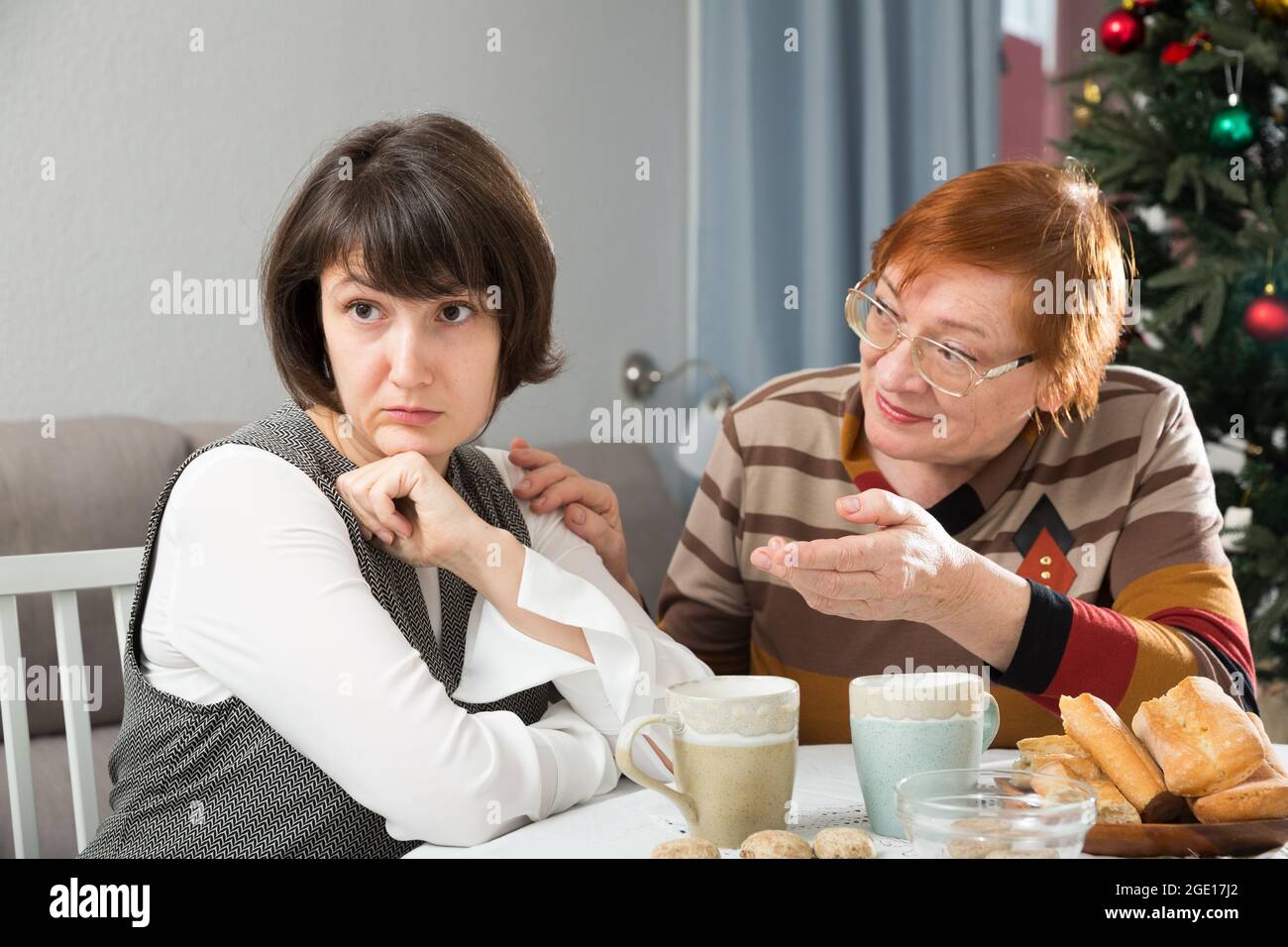 Senior woman calming chagrined female Stock Photo - Alamy