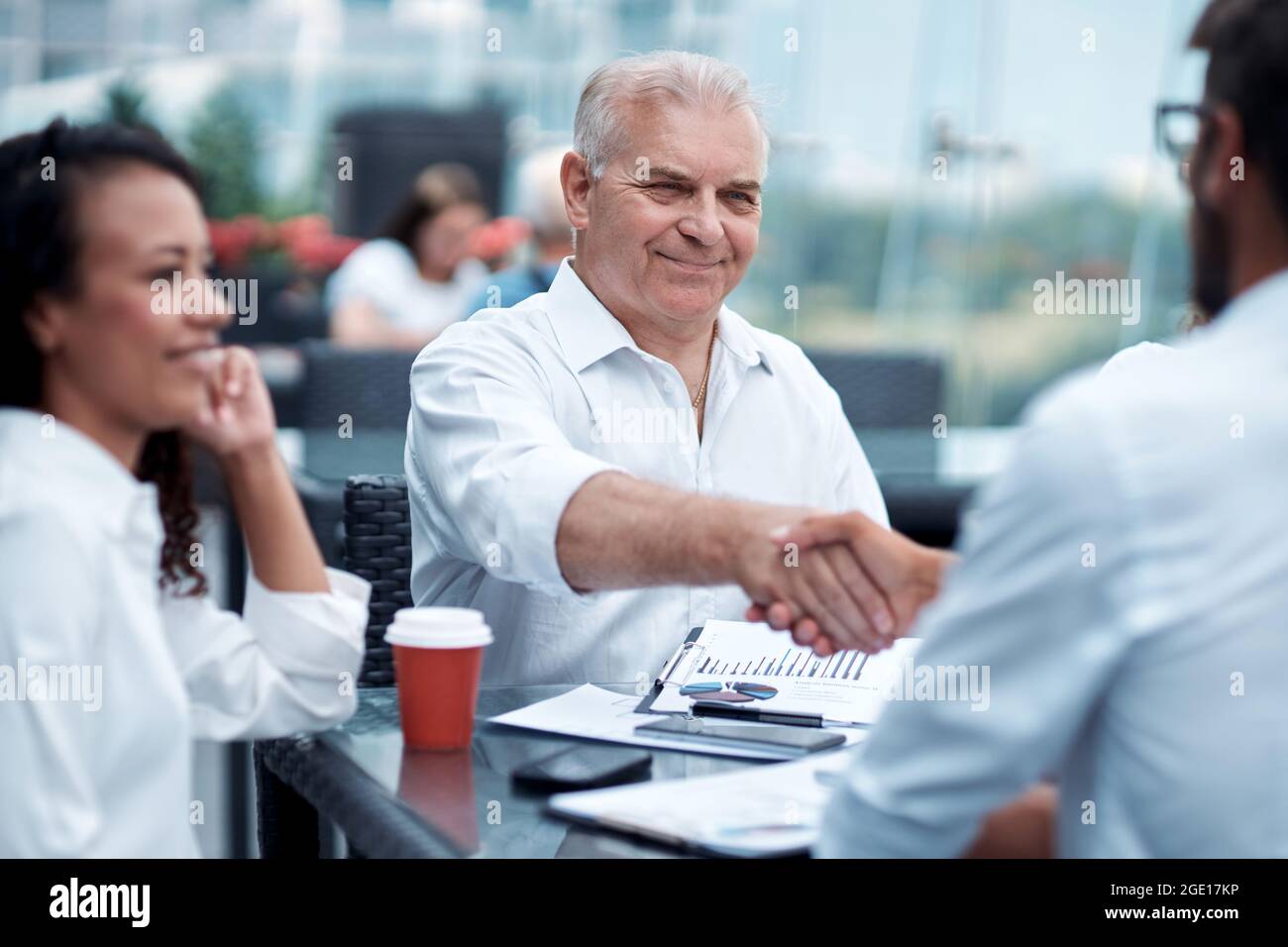 business man shaking hands with his interlocutor Stock Photo - Alamy