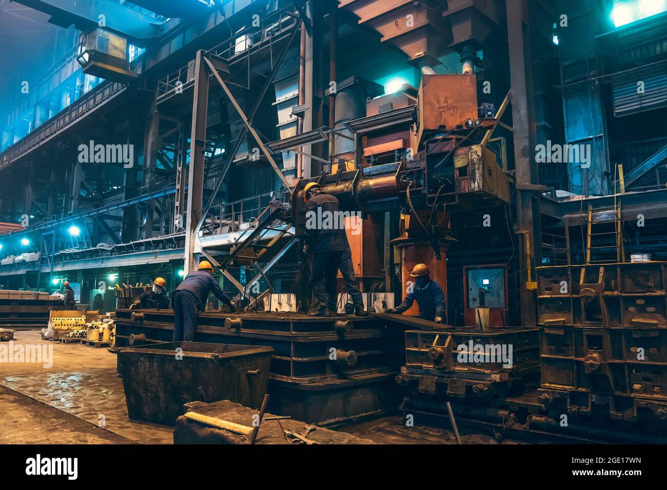 Interior of steel mill. Workers in workshop of metallurgical plant ...