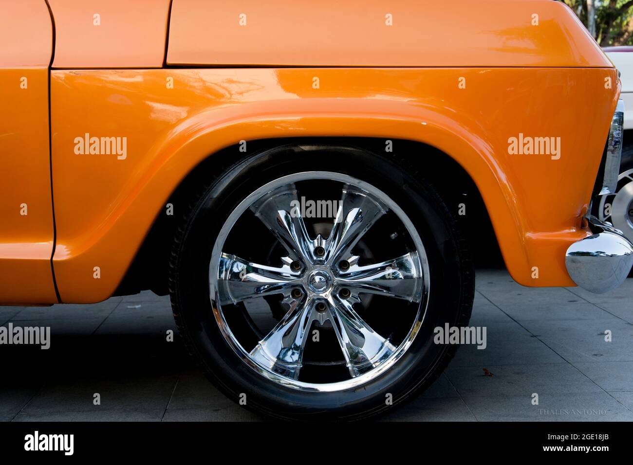 Detail of the wheel of an old car in a light orange color. Salvador ...