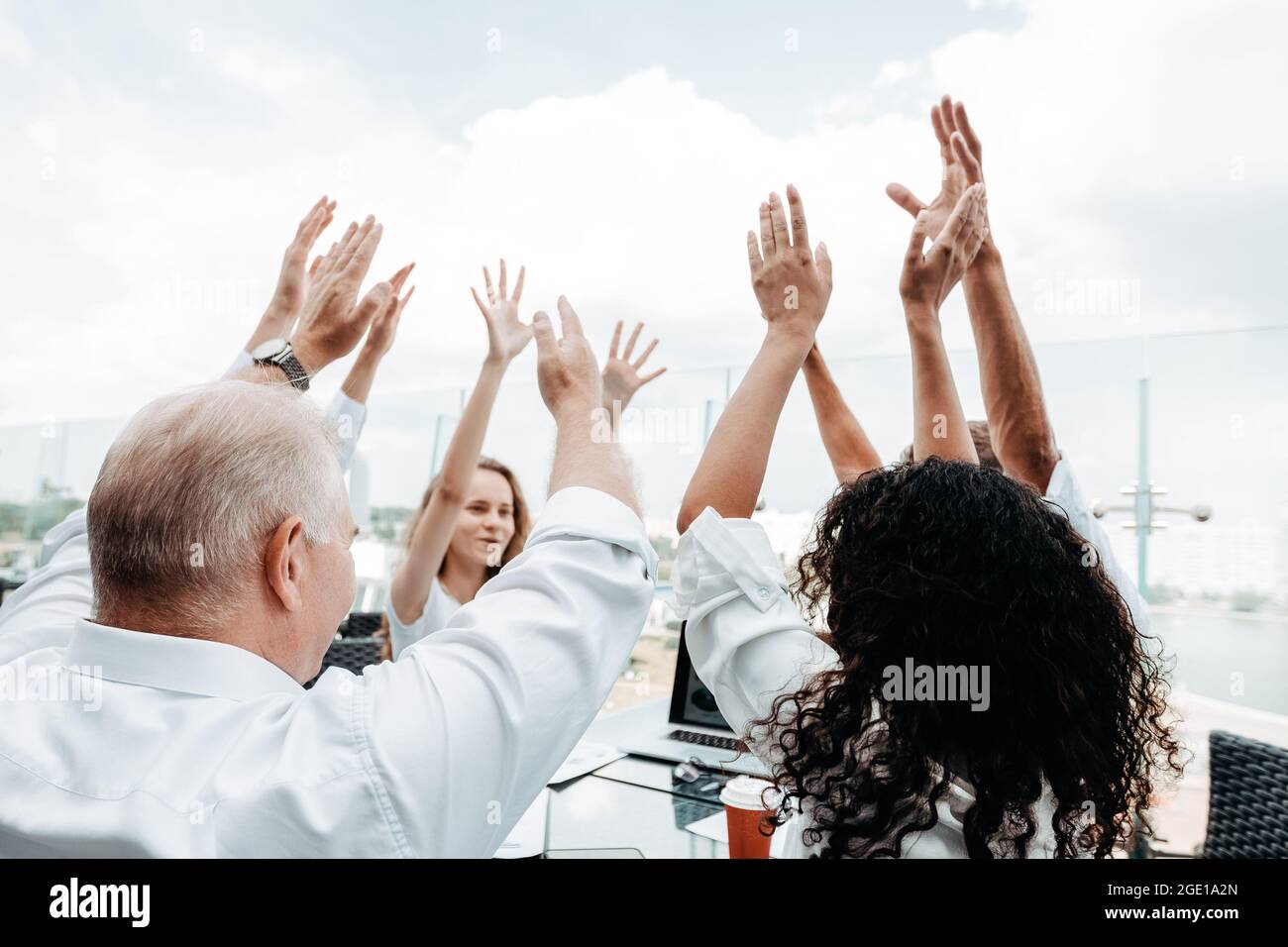 happy business team showing their success with a hand up. concept of ...