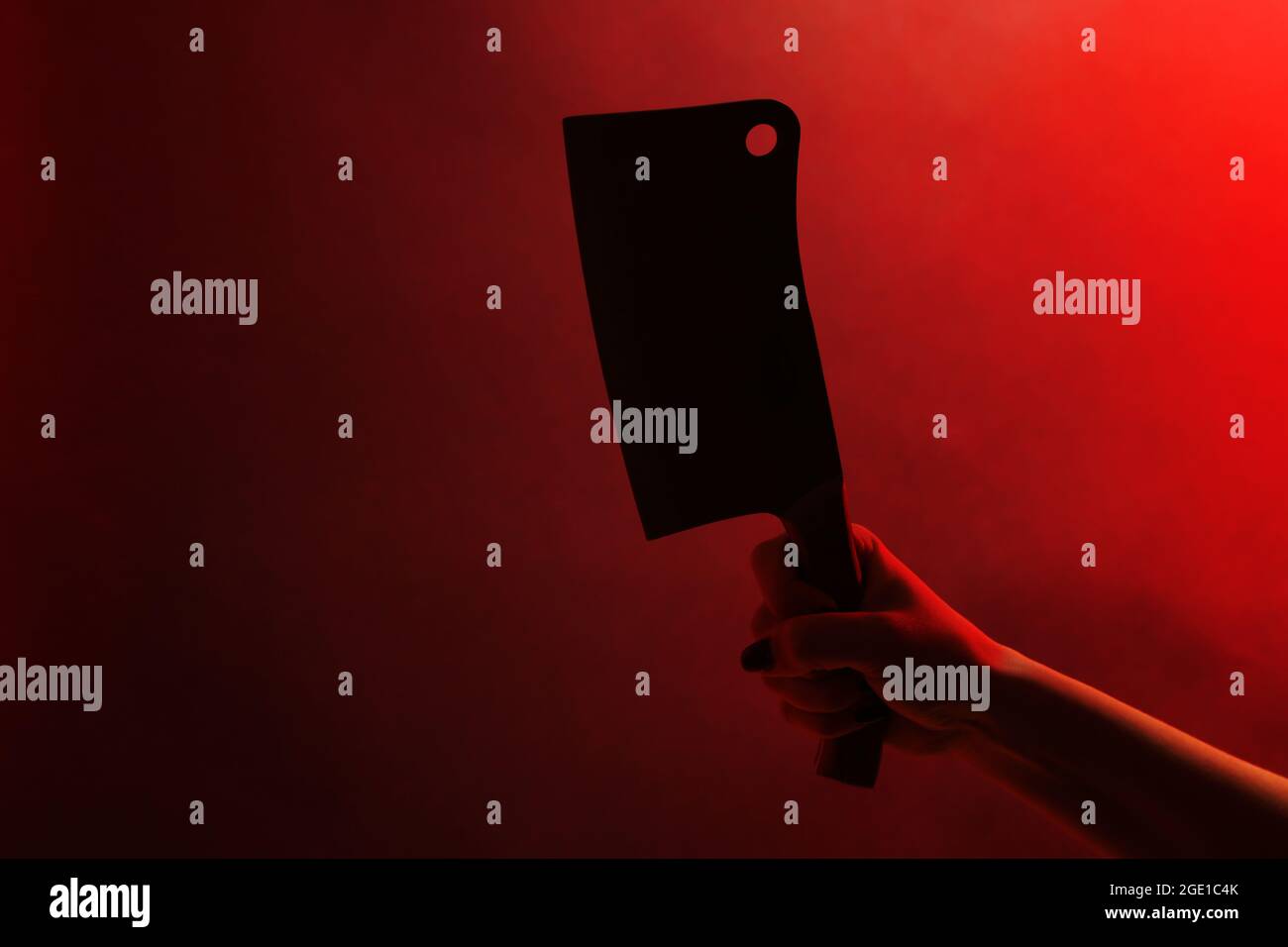 Female hand holding knife on red background Stock Photo - Alamy