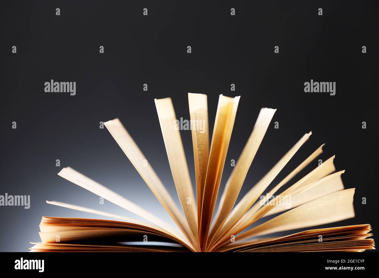 Open book over dark colorful background Stock Photo - Alamy