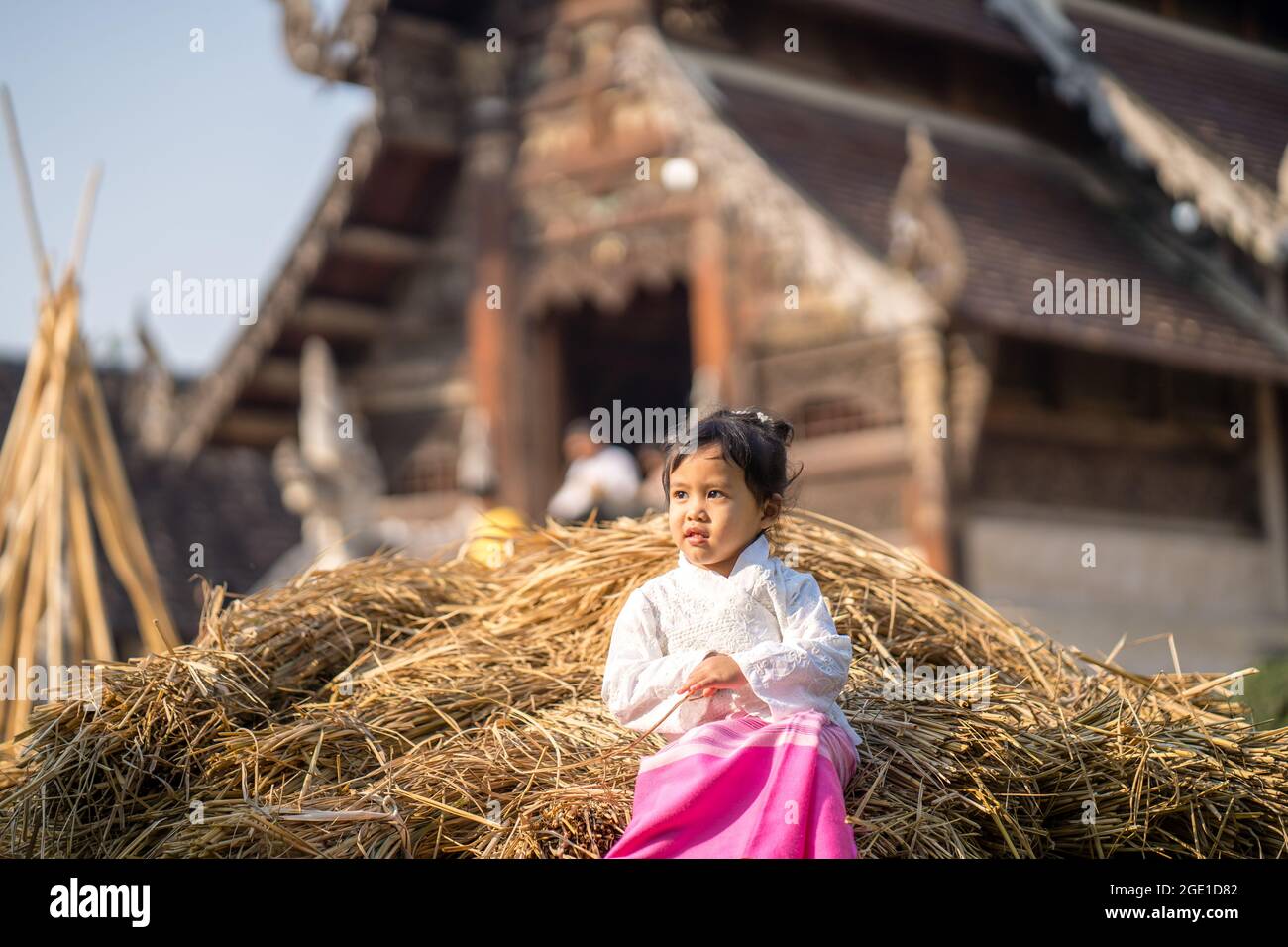 Asian cute little girl wearing traditional Thai dress standing against ...