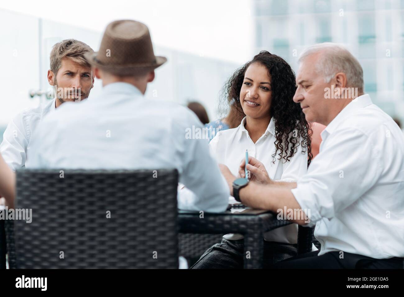 international group of business people sitting at a discussion table ...