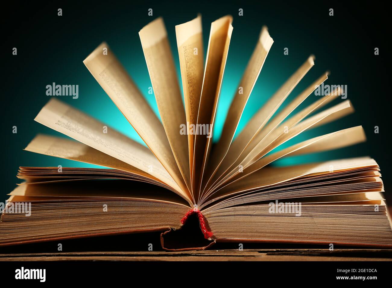 Open book over dark colorful background Stock Photo - Alamy