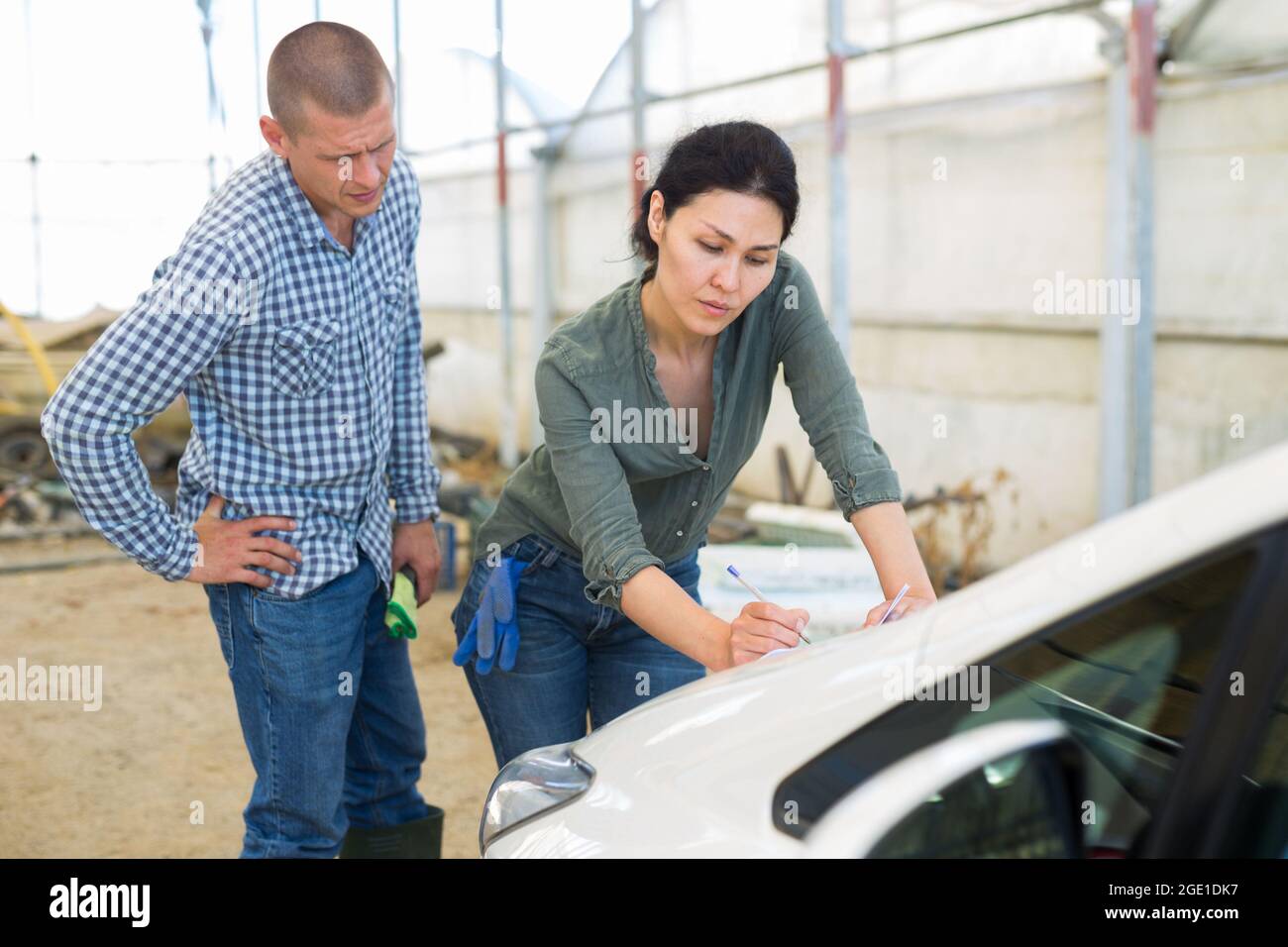 Farmer signing contract with representative of transport company Stock ...