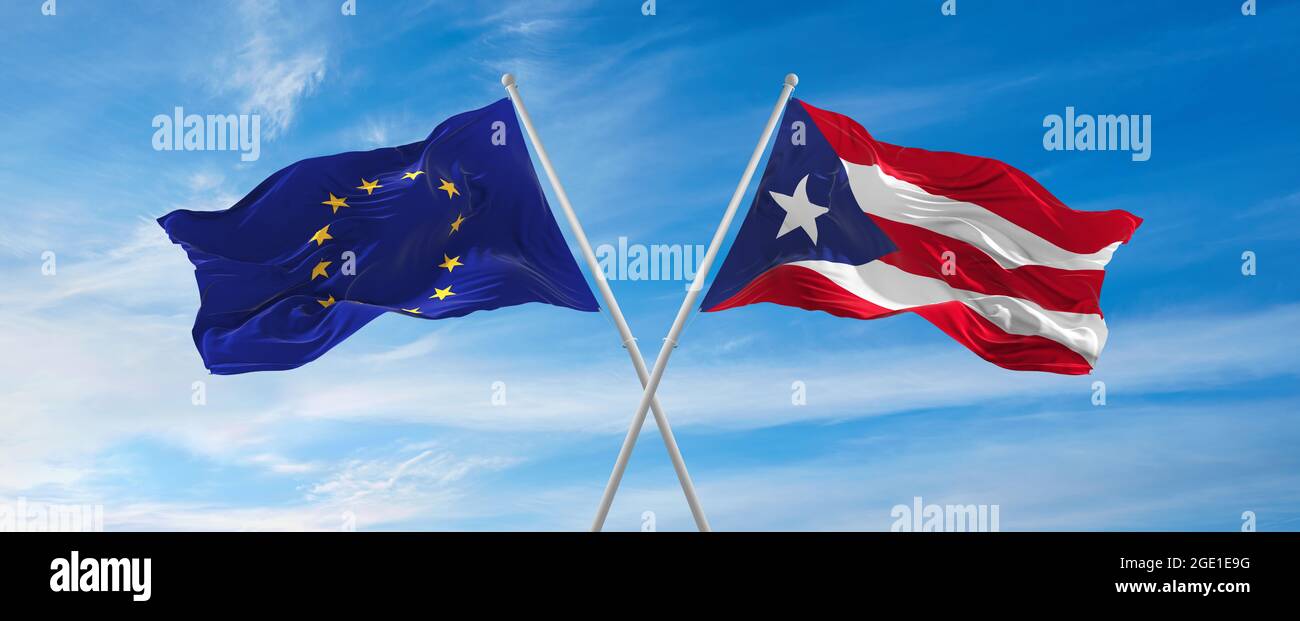 flags of European Union and Puerto Rico waving in the wind on flagpoles ...