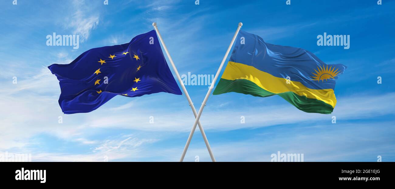 flags of European Union and Rwanda waving in the wind on flagpoles ...
